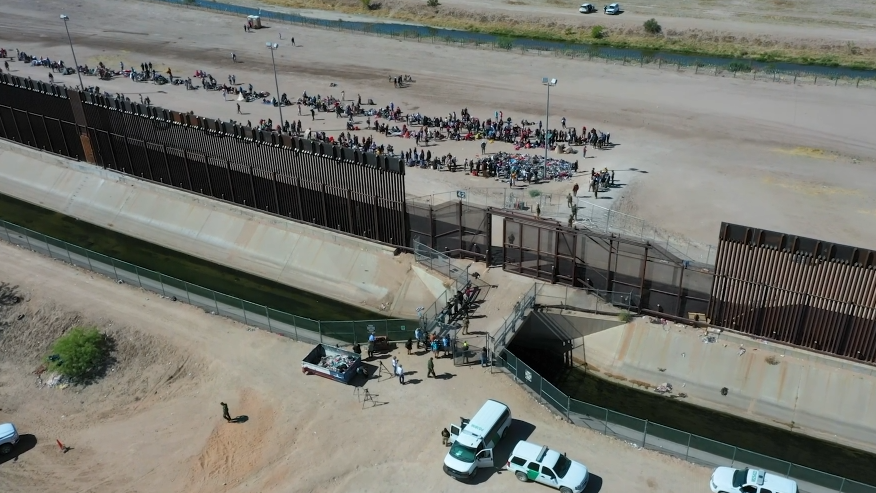 Watch New Drone Footage Of The Border As Migrants Gather To Cross Over